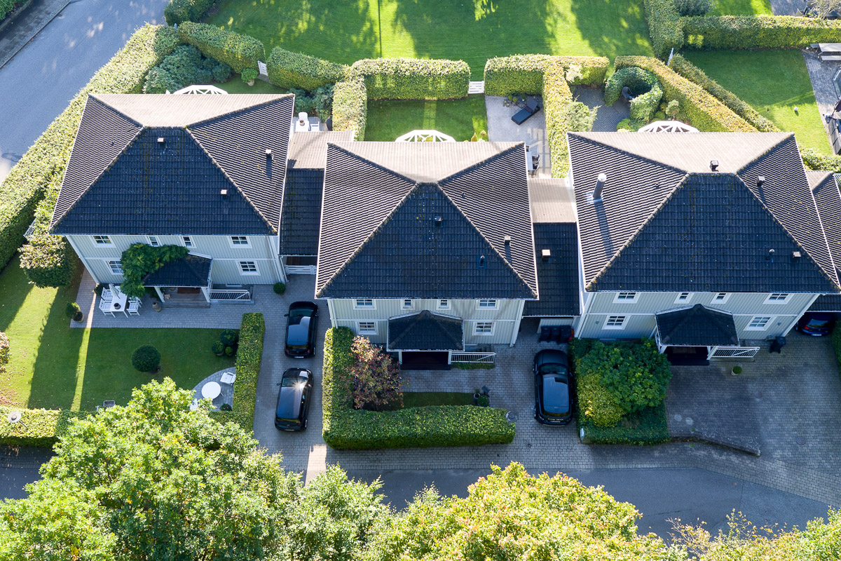 Aerial view of residential neighbourhood. Three identical houses seen ...